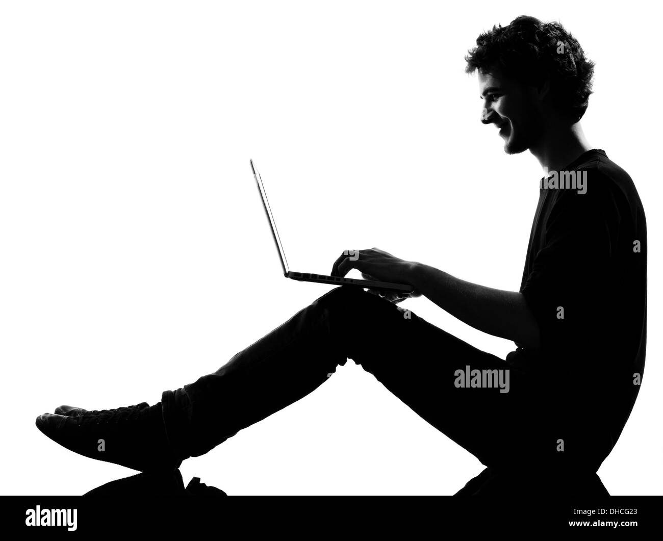 young man silhouette silhouette sitting computing computer laptop in ...