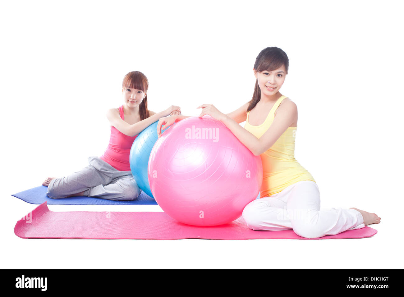 Two young women using exercise balls,smiling Stock Photo - Alamy