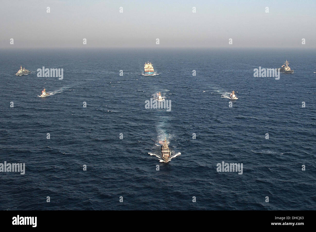 U.S. Coast Guard, Royal Navy and commercial ships sail in formation ...