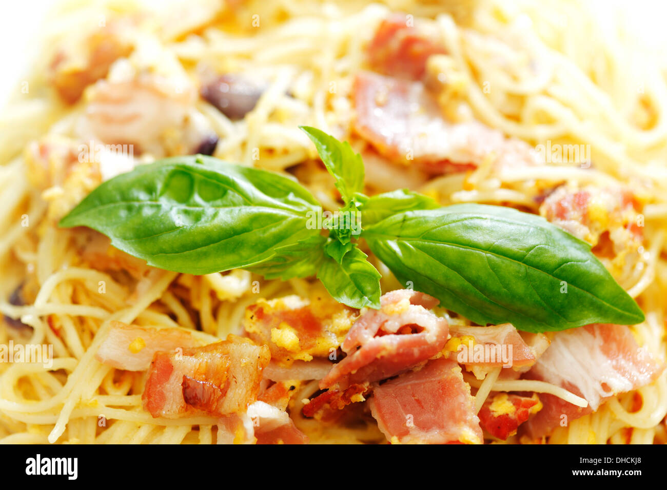 Spaghetti carbonara with fried bacon and basil Stock Photo - Alamy