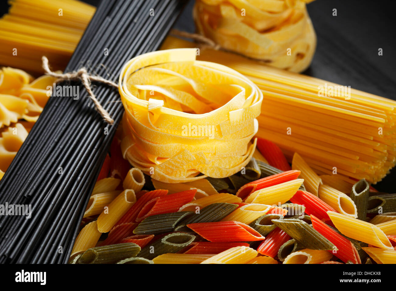 Variety of types and shapes of Italian pasta on black table Stock Photo ...