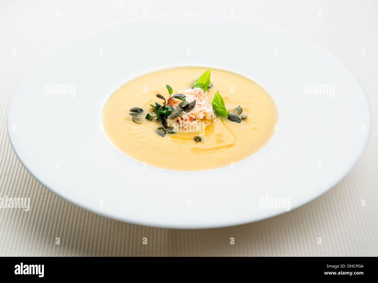 Pumpkin crab soup on a white bowl Stock Photo - Alamy