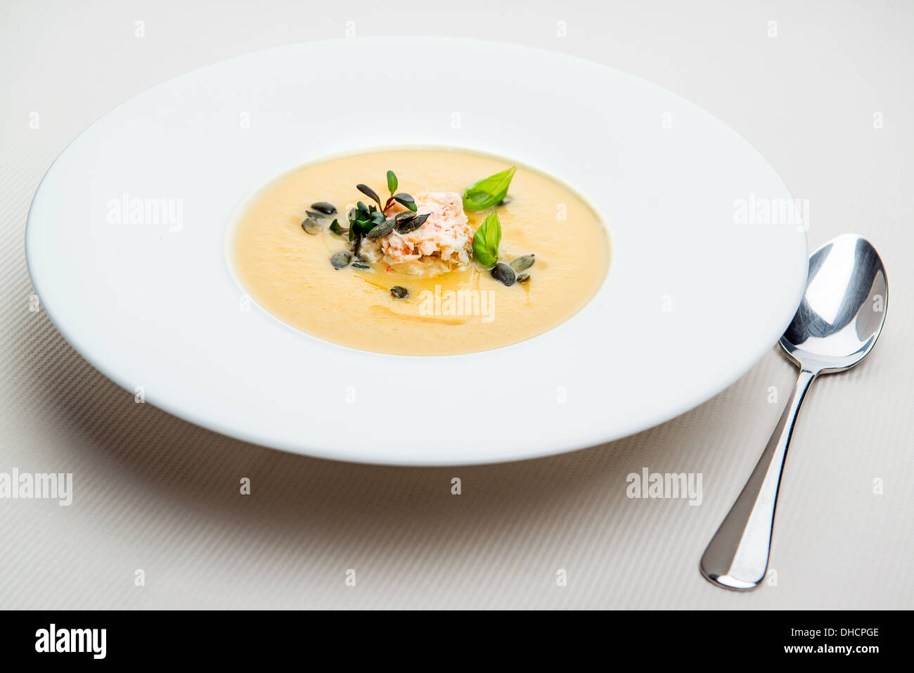 Pumpkin crab soup on a white bowl Stock Photo - Alamy