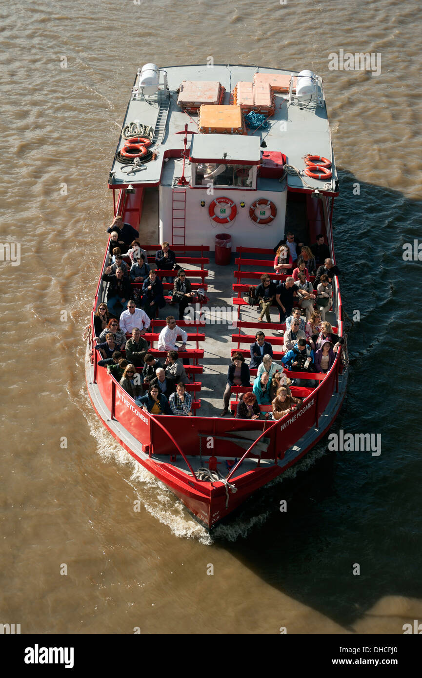Tourist boat goes under Westminster Bridge on the River Thames, London ...