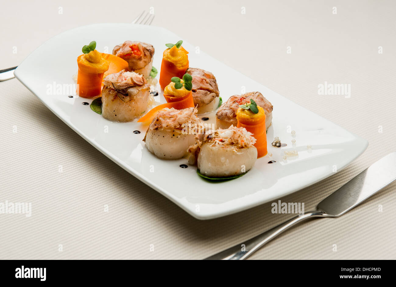 Fish fillet and carrot with pumpkin sauce Stock Photo - Alamy