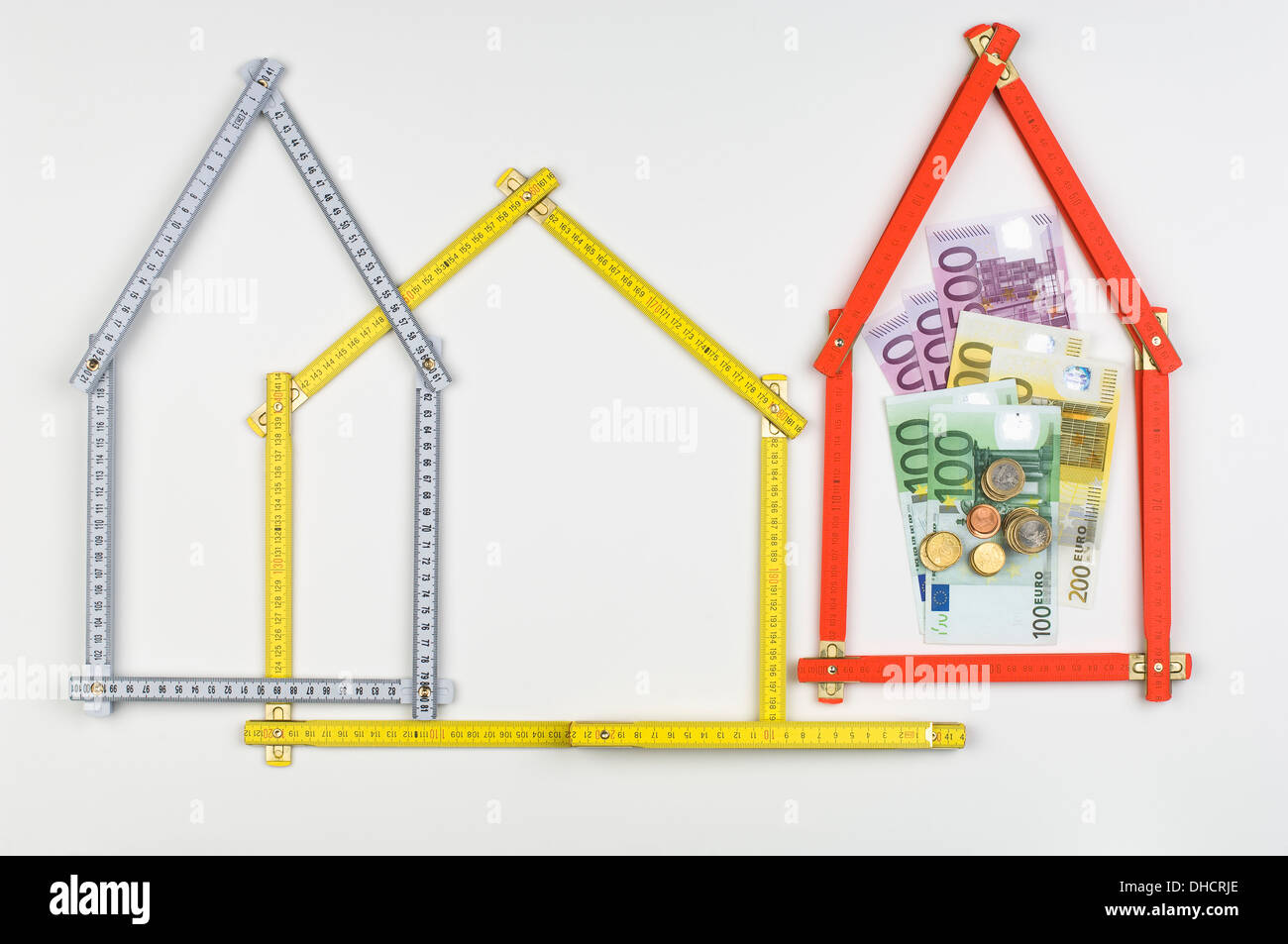 Folded ruler in house shape with banknotes Stock Photo - Alamy