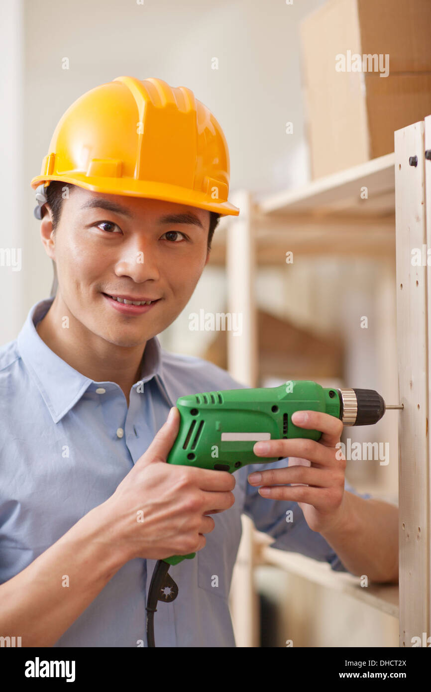 Young businessman using drill hi-res stock photography and images - Alamy