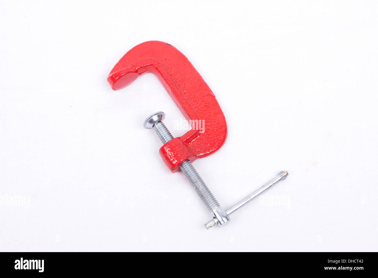 Red clamp isolated on a white background Stock Photo - Alamy