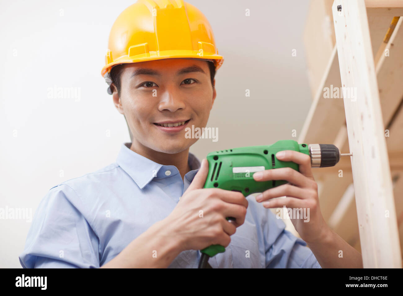 Young businessman using drill hi-res stock photography and images - Alamy