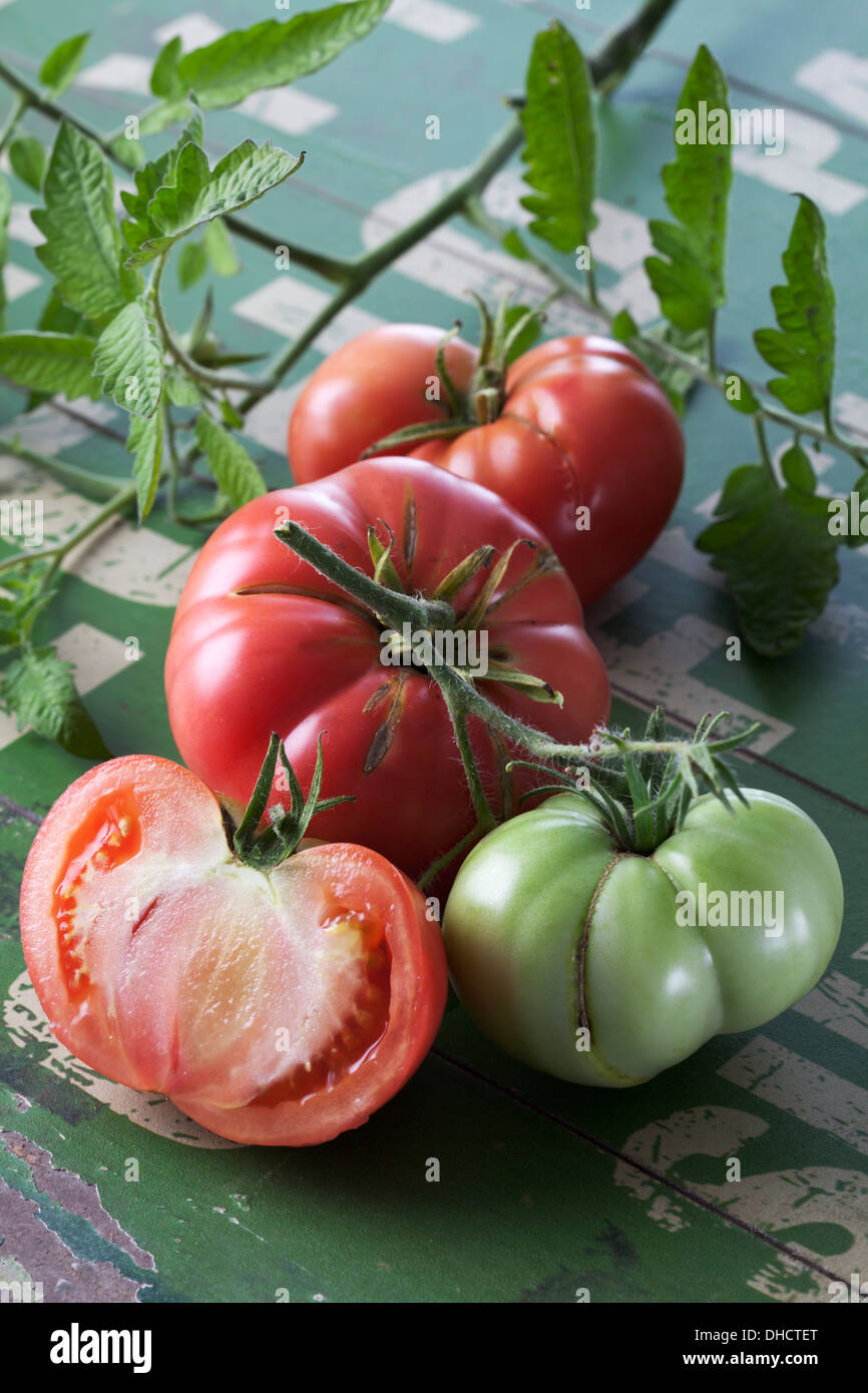 Whole and sliced Silesian raspberry tomatoes (Solanum lycopersicum ...