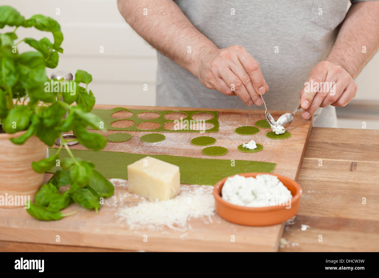 Man preparing green ravioli with ricotta Stock Photo - Alamy