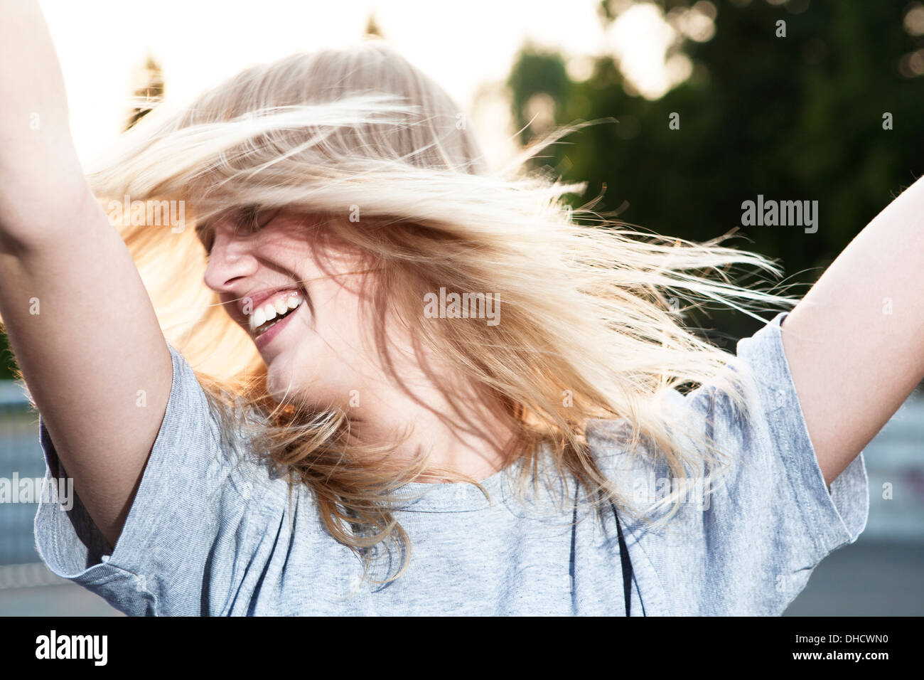 Young woman tossing her hair Stock Photo - Alamy