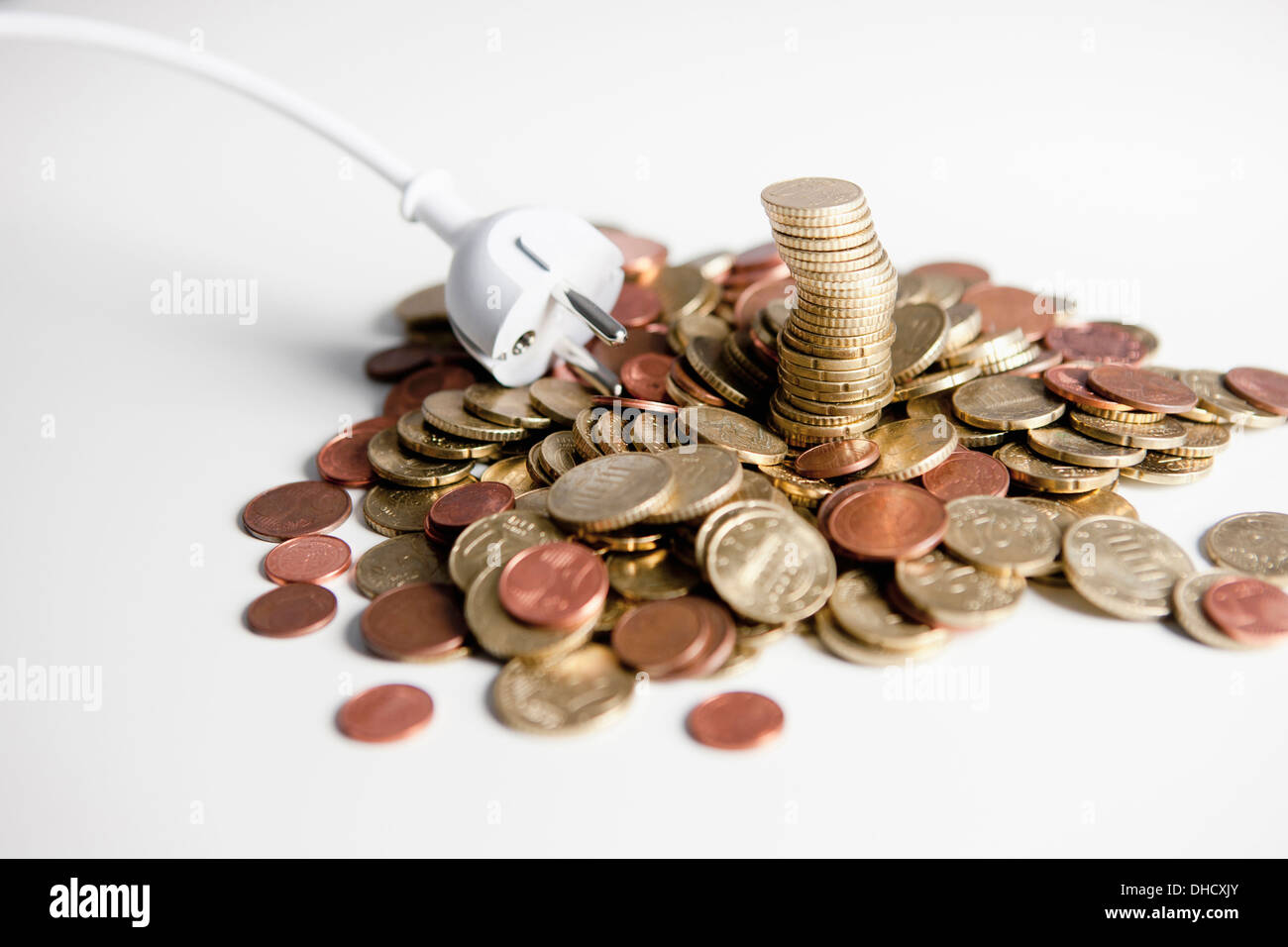 Studio, electric cable and plug, pile of Euro coins Stock Photo - Alamy