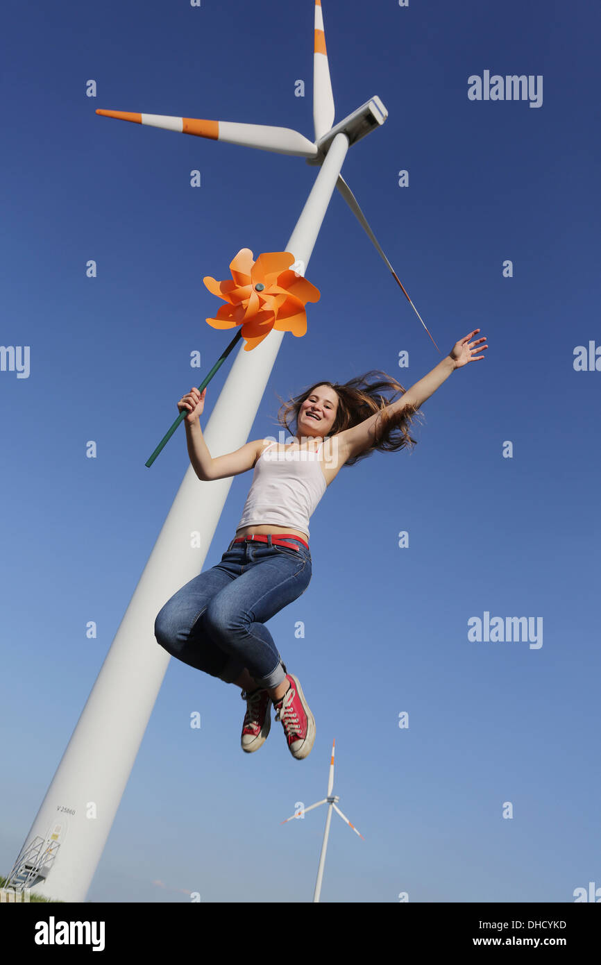 Germany, North Rhine Westphalia, Neuss, female teenager at wind farm ...