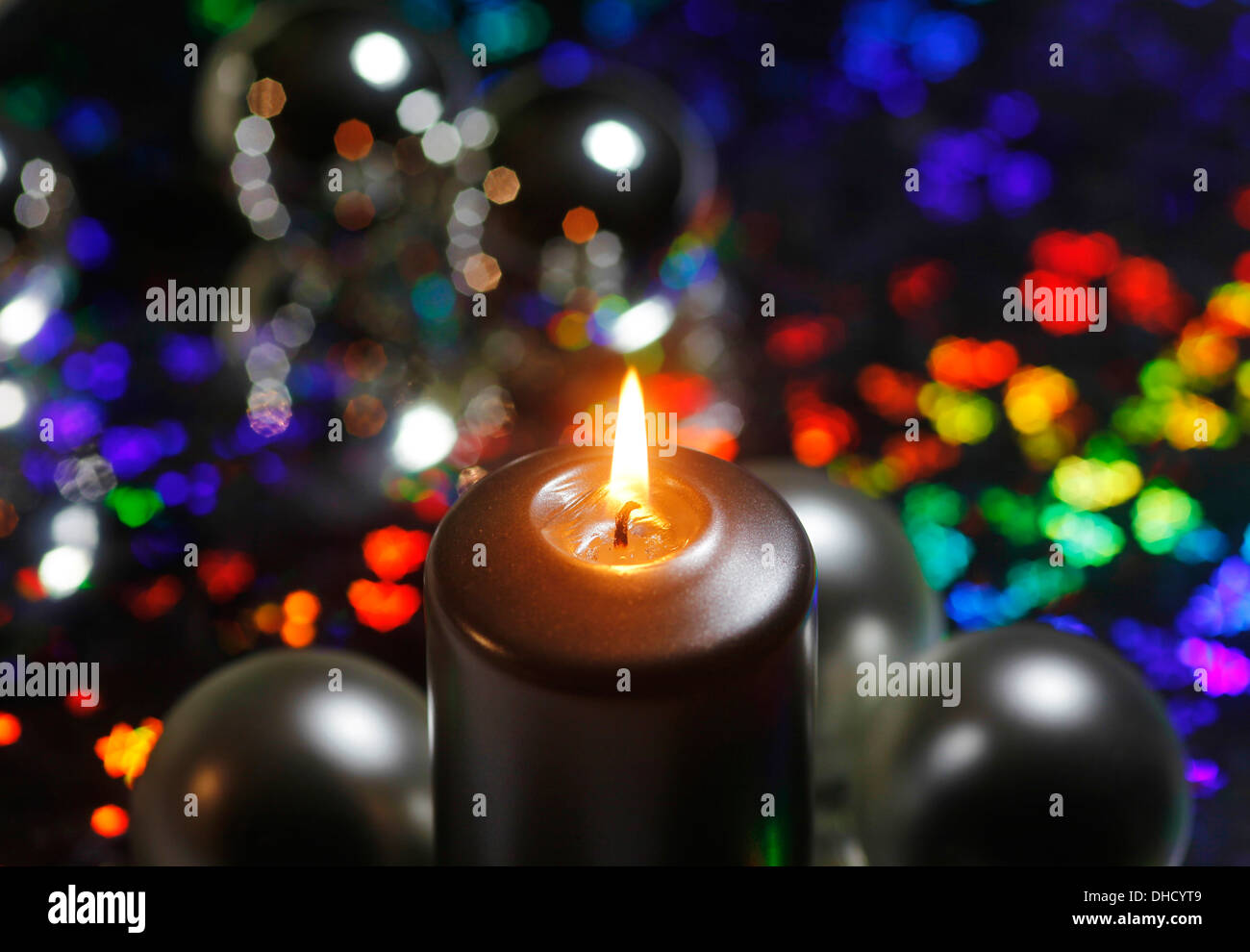 Candlelight in front of luminous colourful background Stock Photo - Alamy