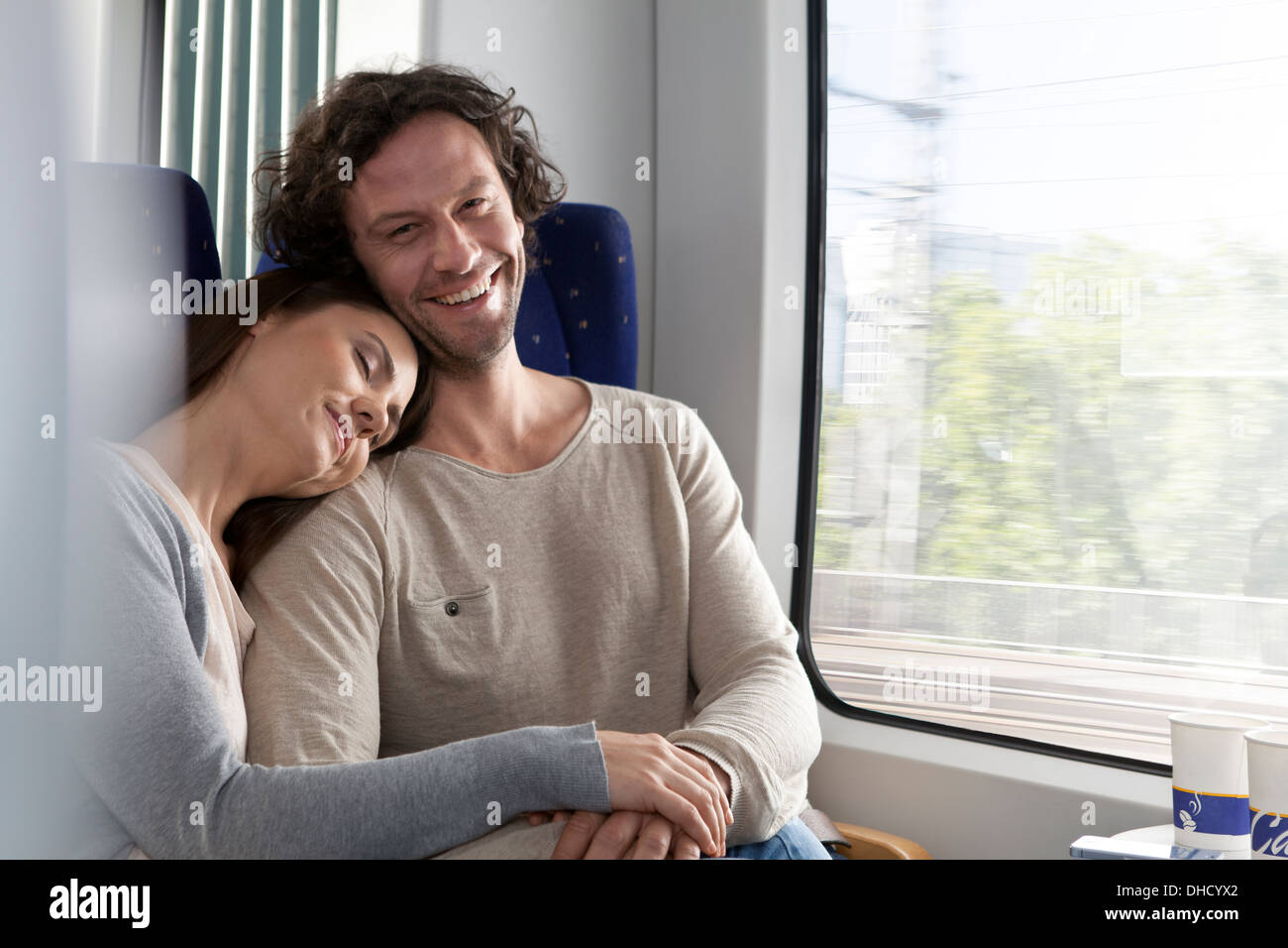 Relaxed couple in a train Stock Photo - Alamy