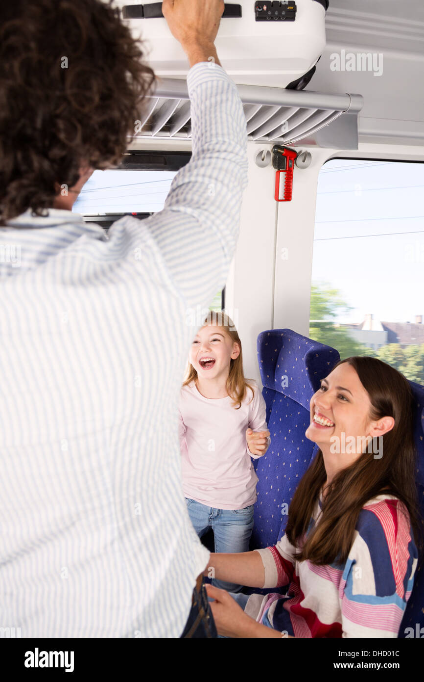 Happy family in a train Stock Photo - Alamy