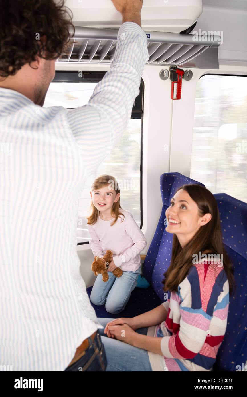 Happy family in a train Stock Photo - Alamy