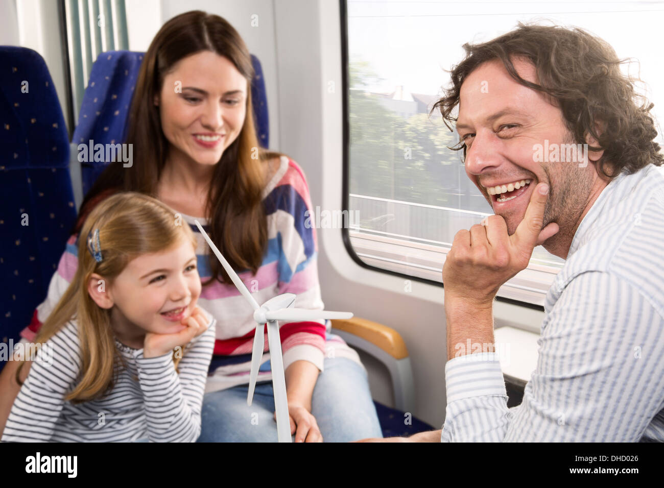 Happy family in a train Stock Photo - Alamy