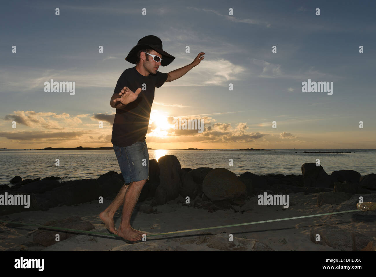 France, Bretagne, Landeda, Man balancing on slackline on beach Stock ...