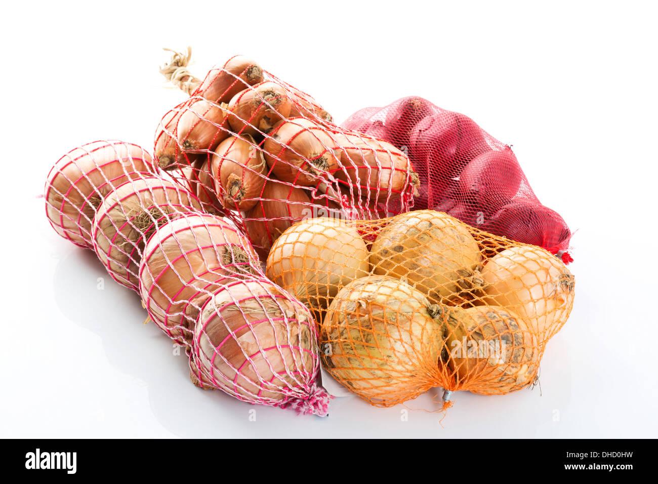 Studio, variety of onions in a net Stock Photo - Alamy