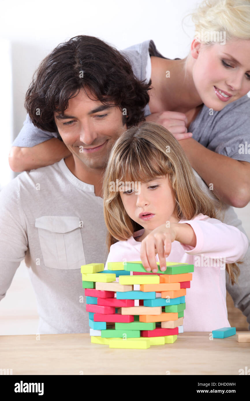parents looking her daughter playing with blocks Stock Photo - Alamy