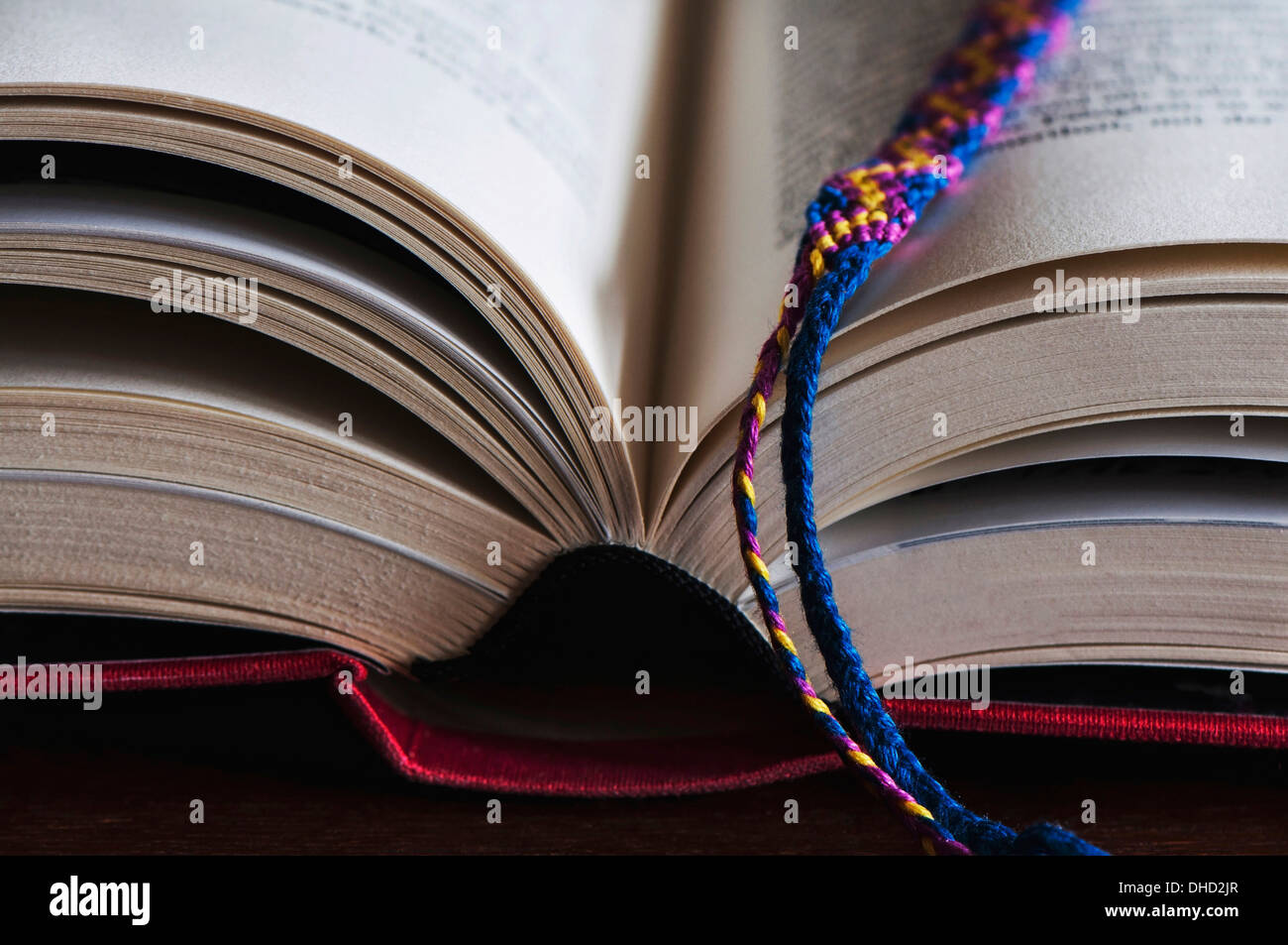 Part of an opened book with bookmark Stock Photo - Alamy