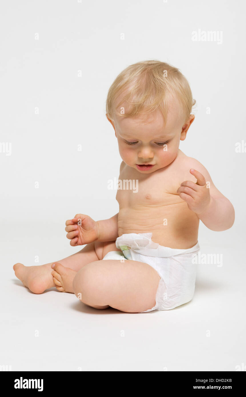 Baby boy wearing diapers against white backgound Stock Photo - Alamy