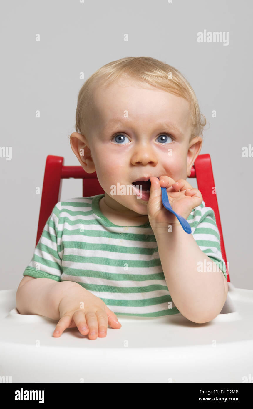Cute boy holding spoon hi-res stock photography and images - Alamy