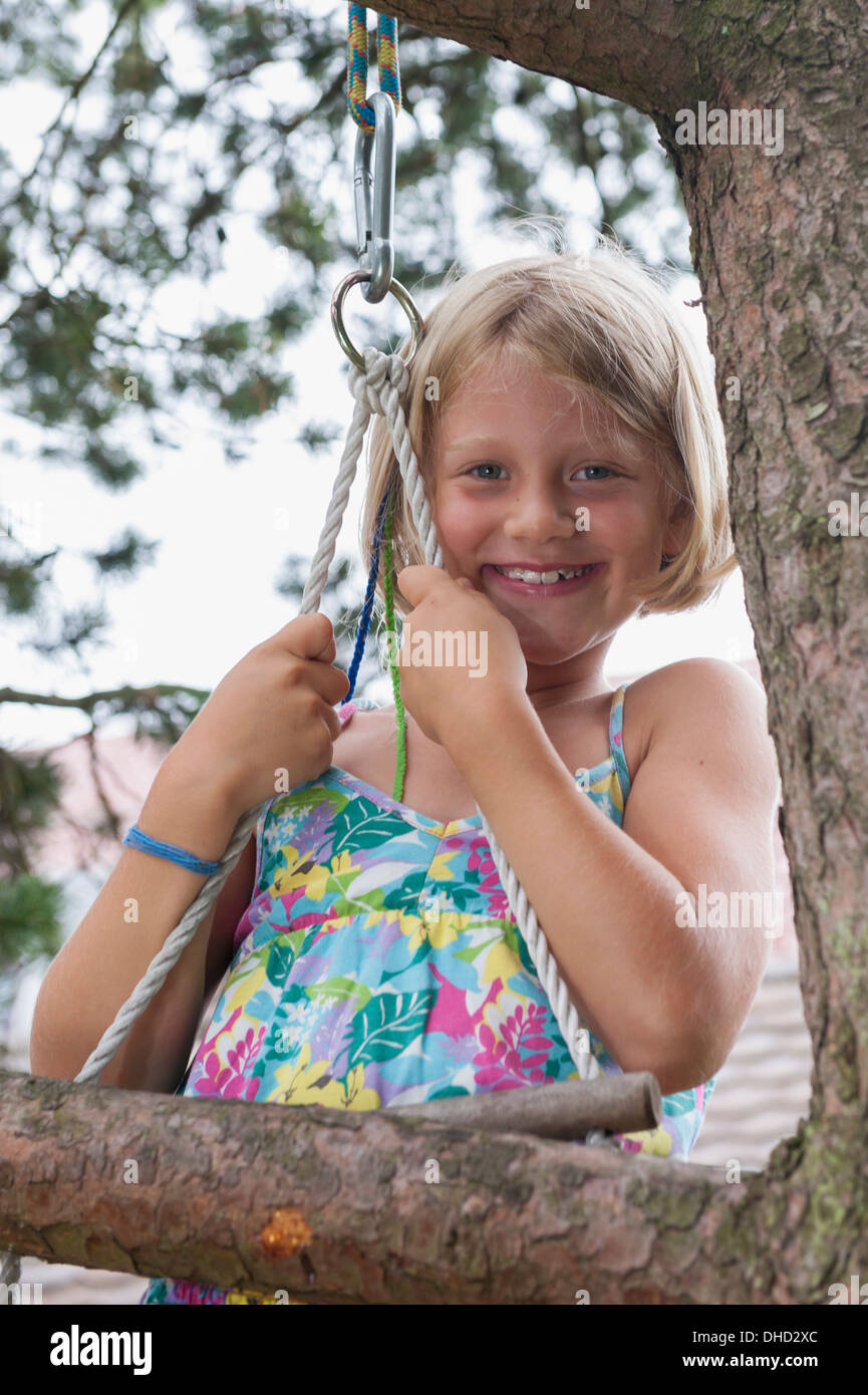 Smiling girl in a tree Stock Photo - Alamy