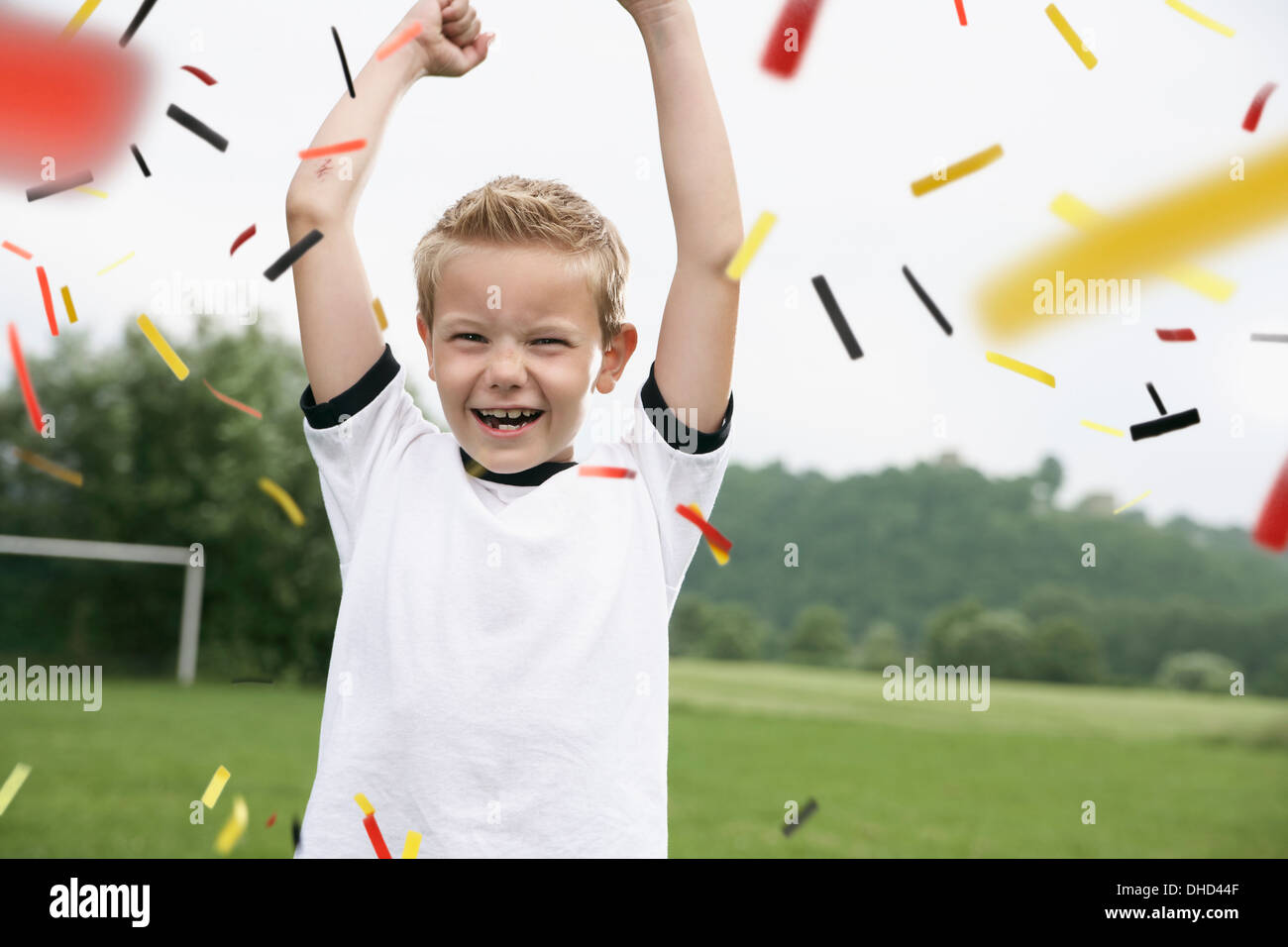 Boy in soccer jersey cheering on soccer pitch Stock Photo - Alamy