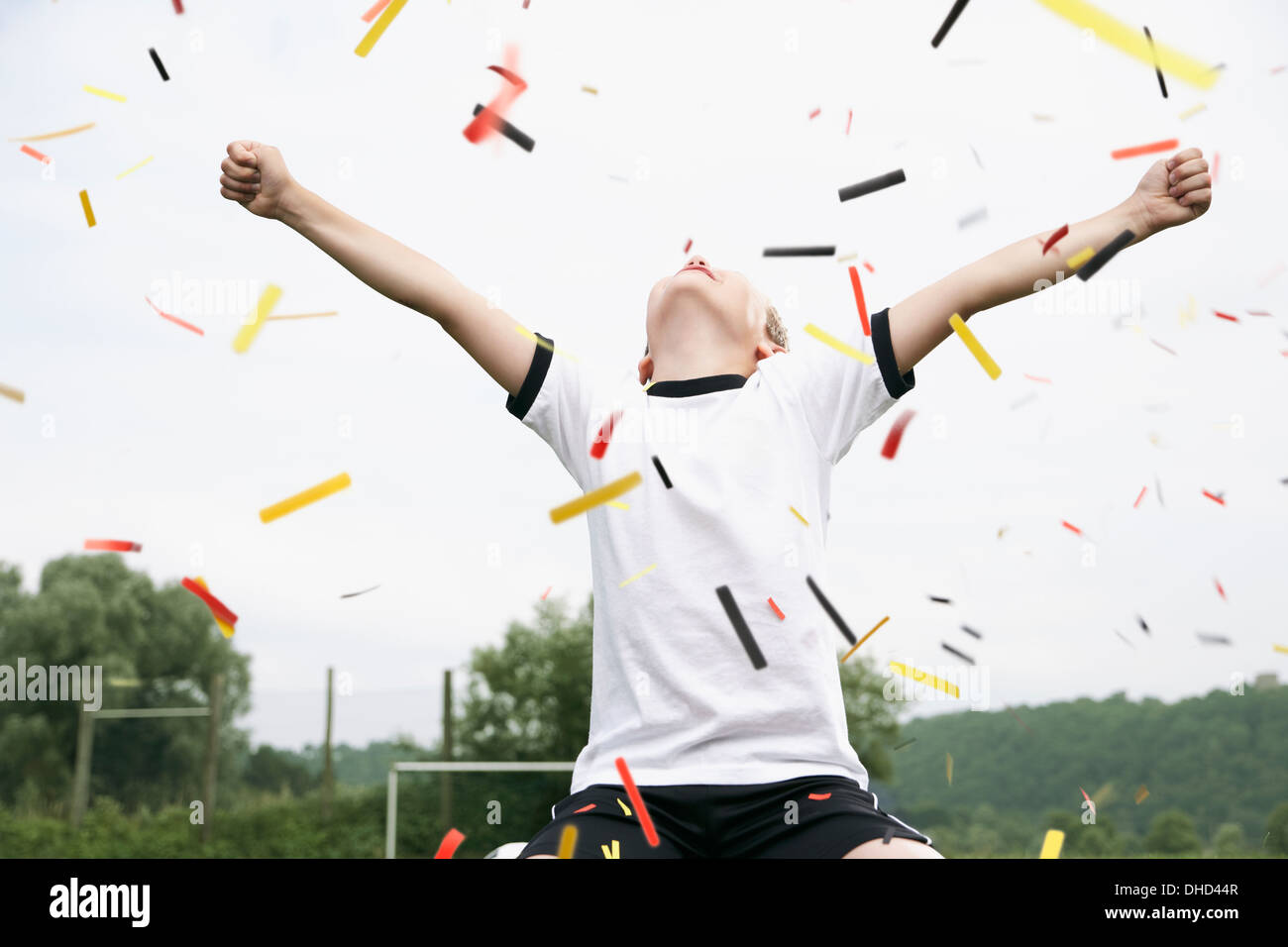 Boy in soccer jersey cheering on soccer pitch Stock Photo - Alamy
