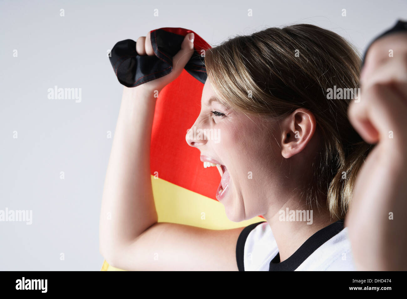 Female soccer fan rooting for German team Stock Photo - Alamy