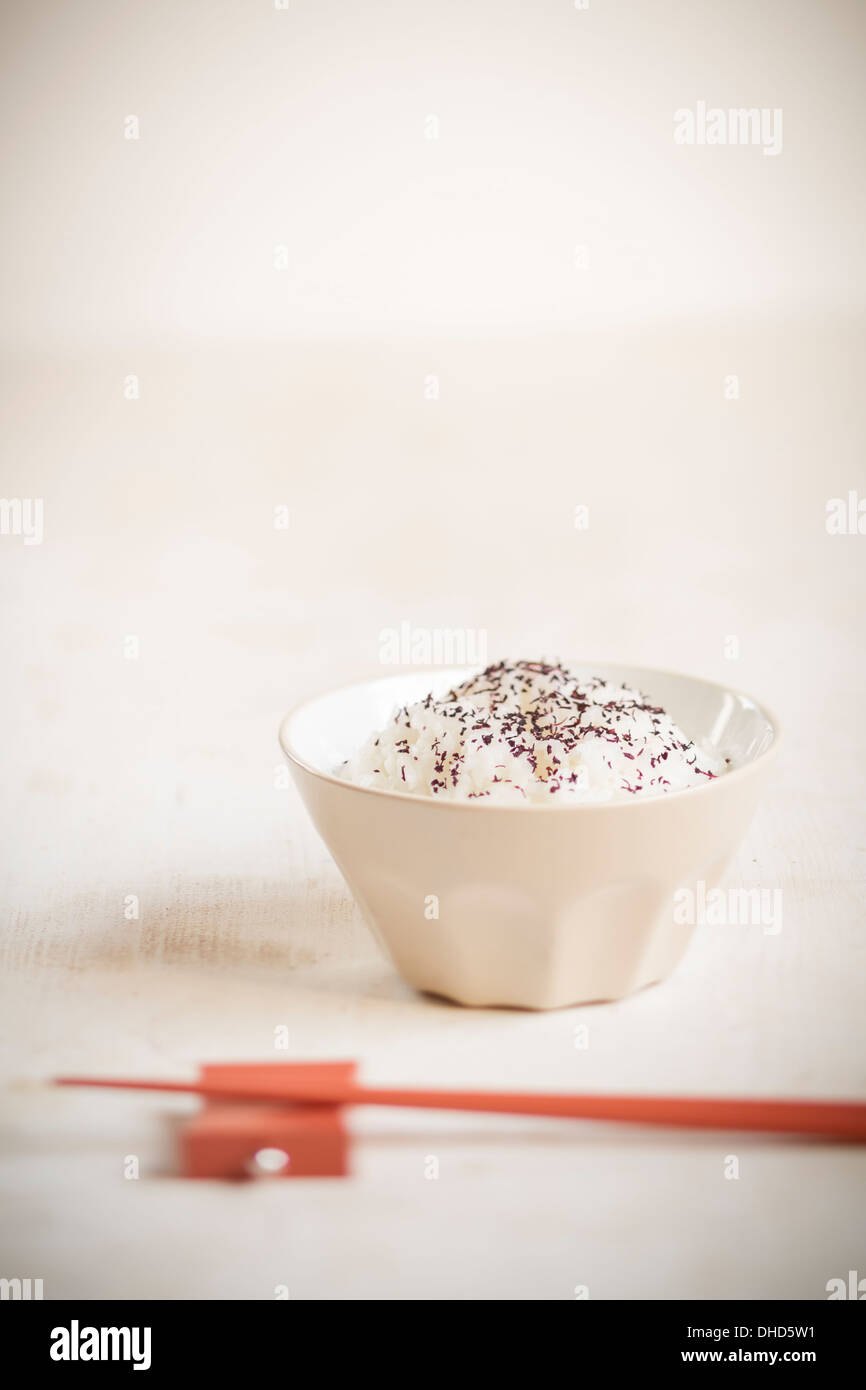 Bowl with japanese rice, sprinkled with Furikake, chopsticks in front ...