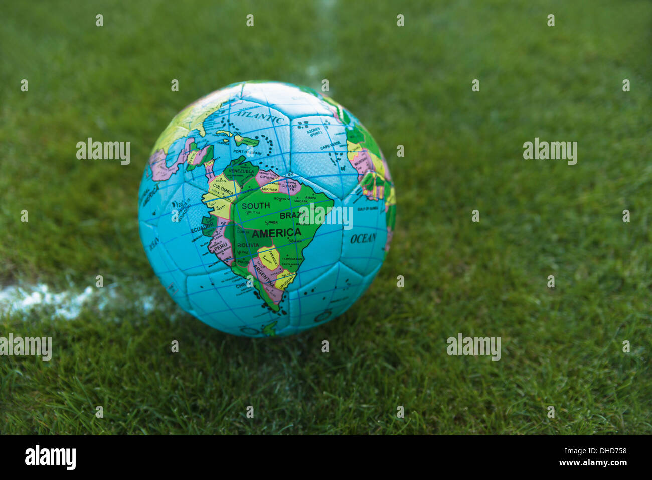 Soccer ball on football ground Stock Photo - Alamy