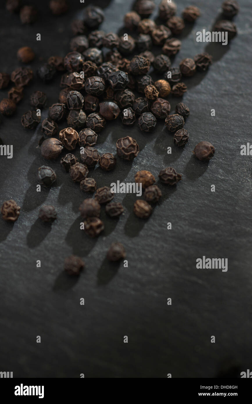 Pepper corns on slate Stock Photo - Alamy