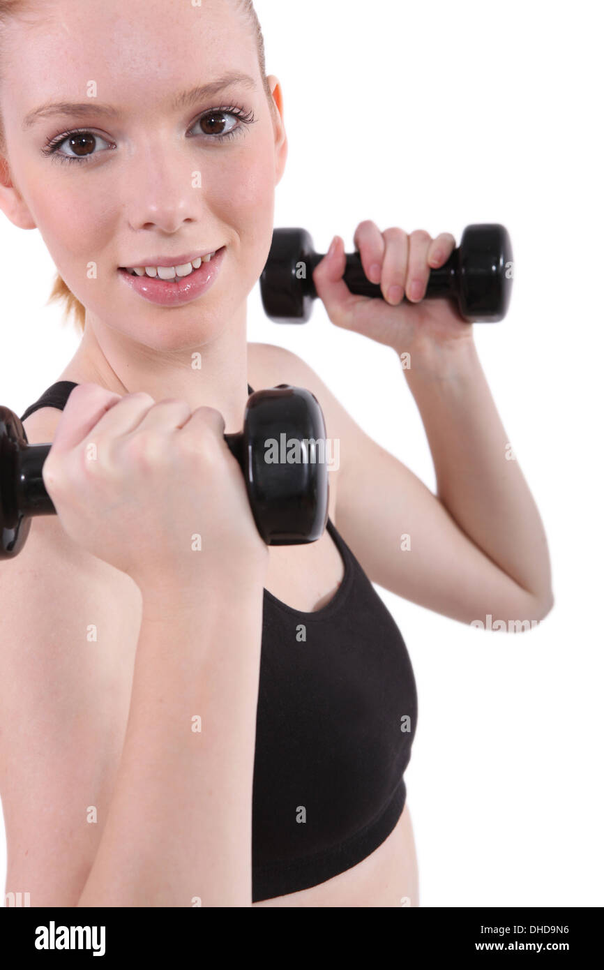 Woman using small dumbbells Stock Photo - Alamy