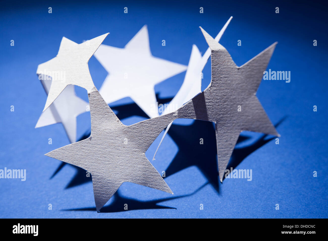 Paper stars group on a colour background Stock Photo - Alamy