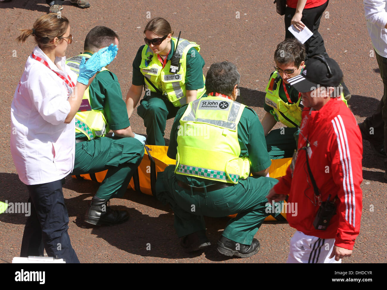 A runner collapsed after running Marathon and is helped by ambulance ...