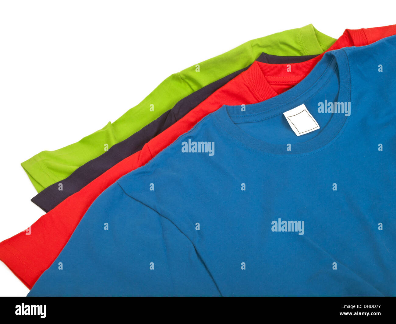 four colorful t shirts isolated on white background Stock Photo - Alamy