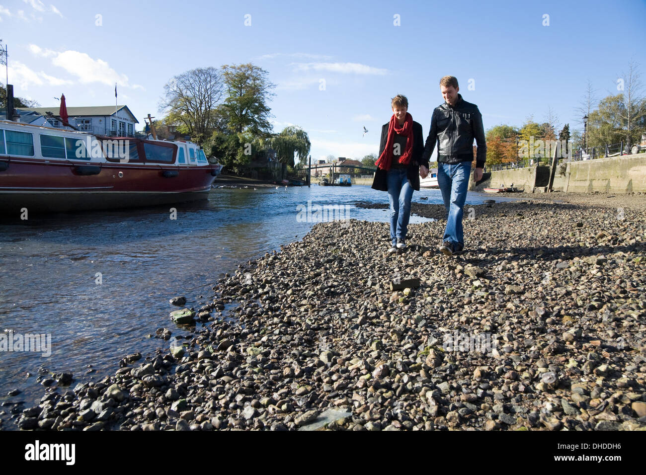 River Thames Twickenham riverside. Couple / people walk / walking along ...