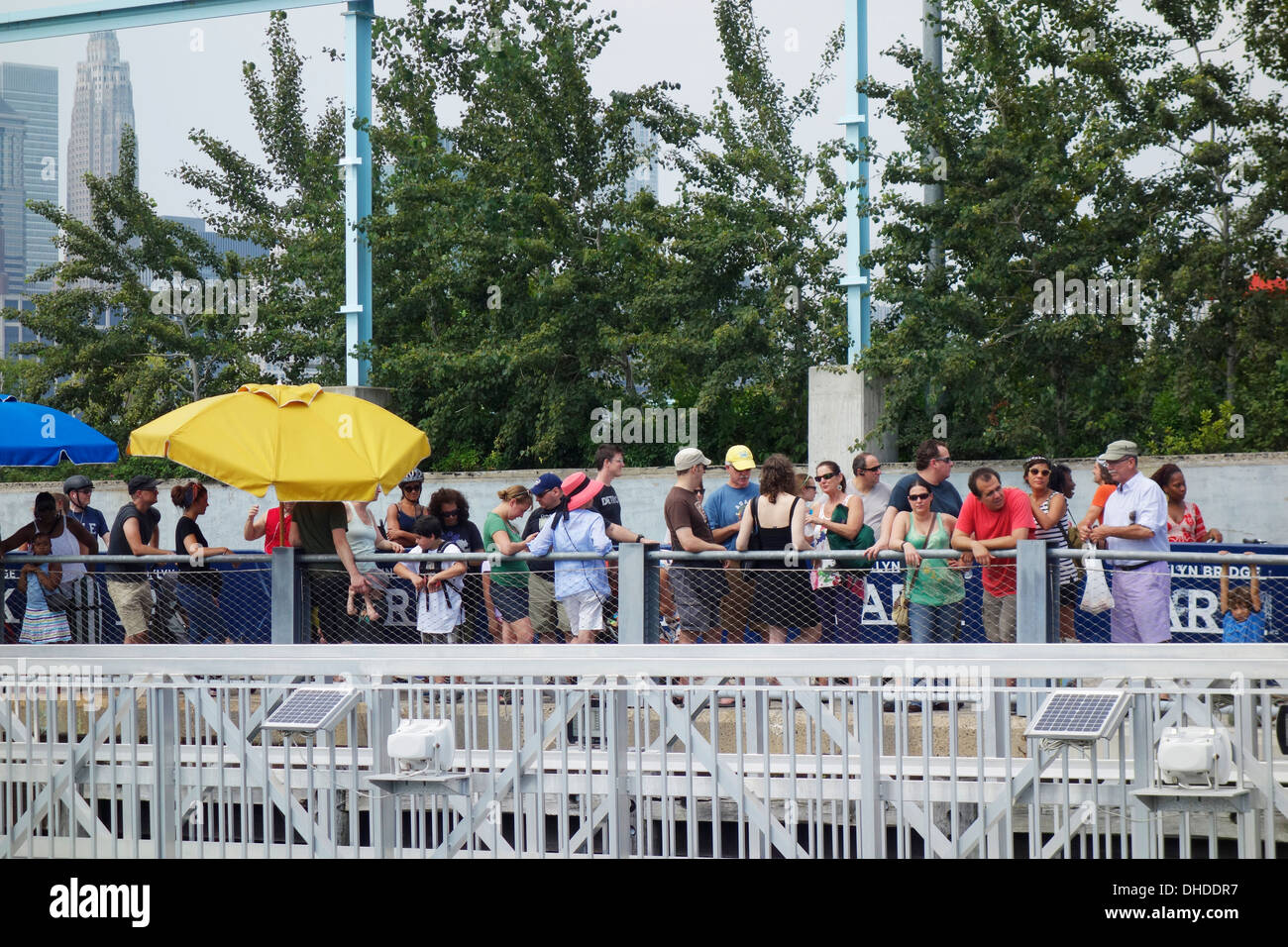 crowd waiting in line for ferry to Governors island Stock Photo - Alamy