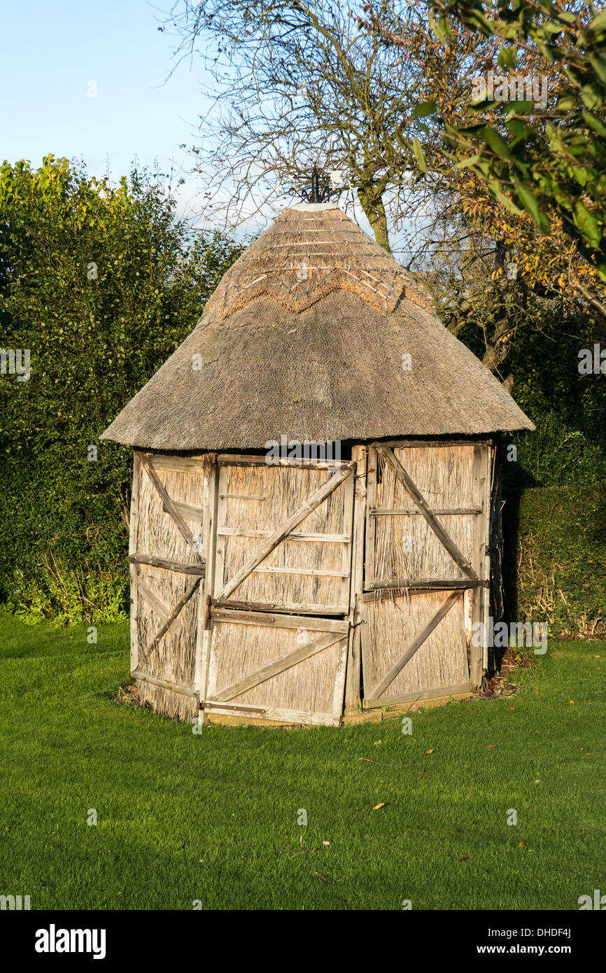 thatched shed in garden with reed panels for sides and door Stock Photo ...