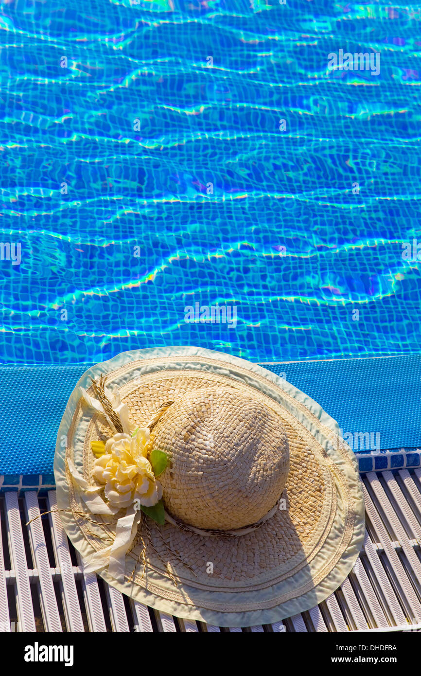 The straw hat lies on the brink of pool Stock Photo - Alamy