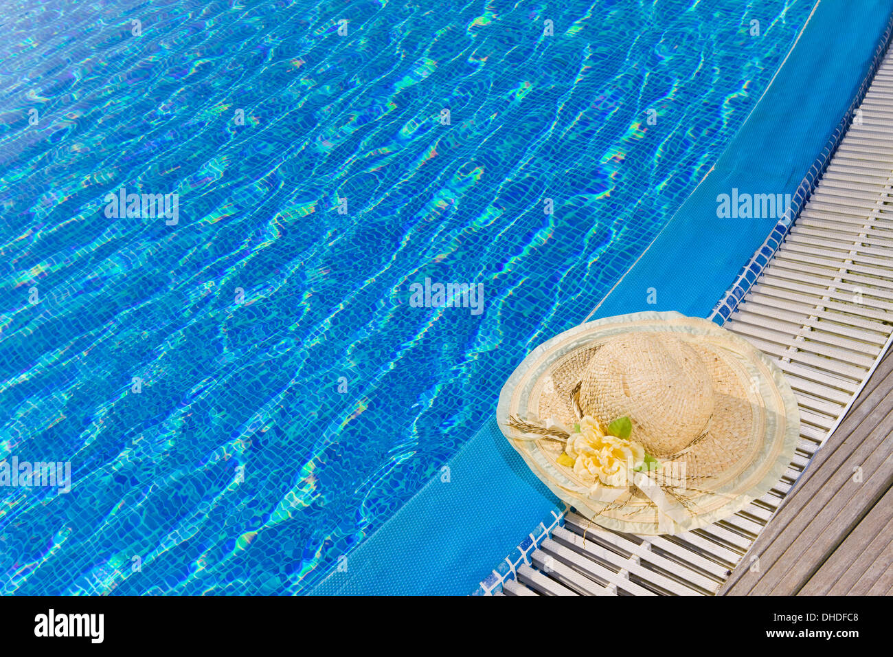 The straw hat lies on the brink of pool Stock Photo - Alamy