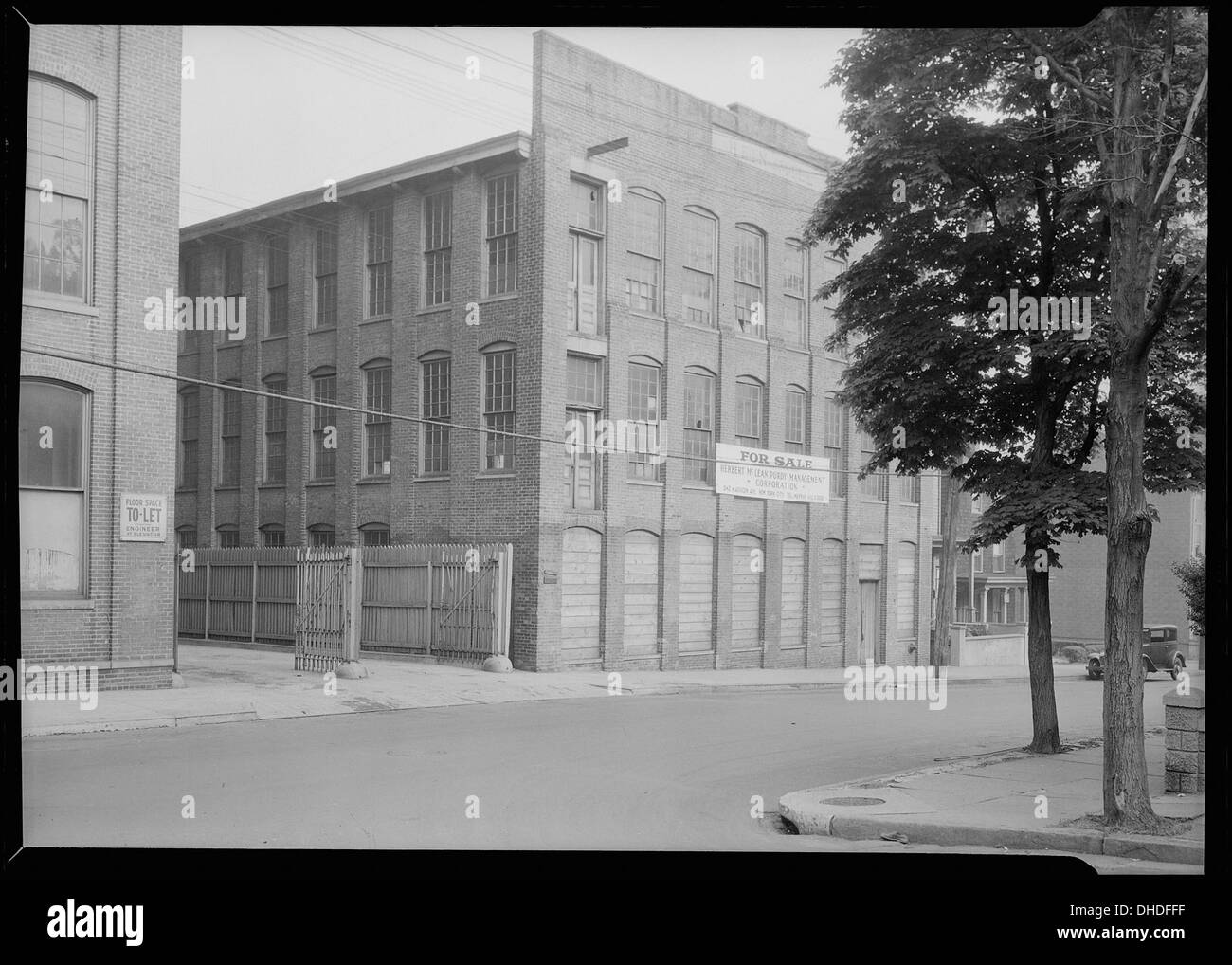 The photograph depicts unoccupied textile mill buildings on Straight ...