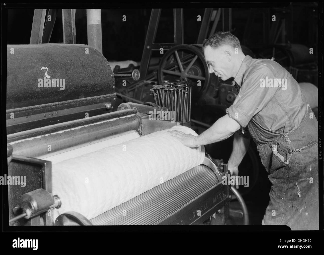 This photograph shows a worker operating the Finisher Lapper machine at ...