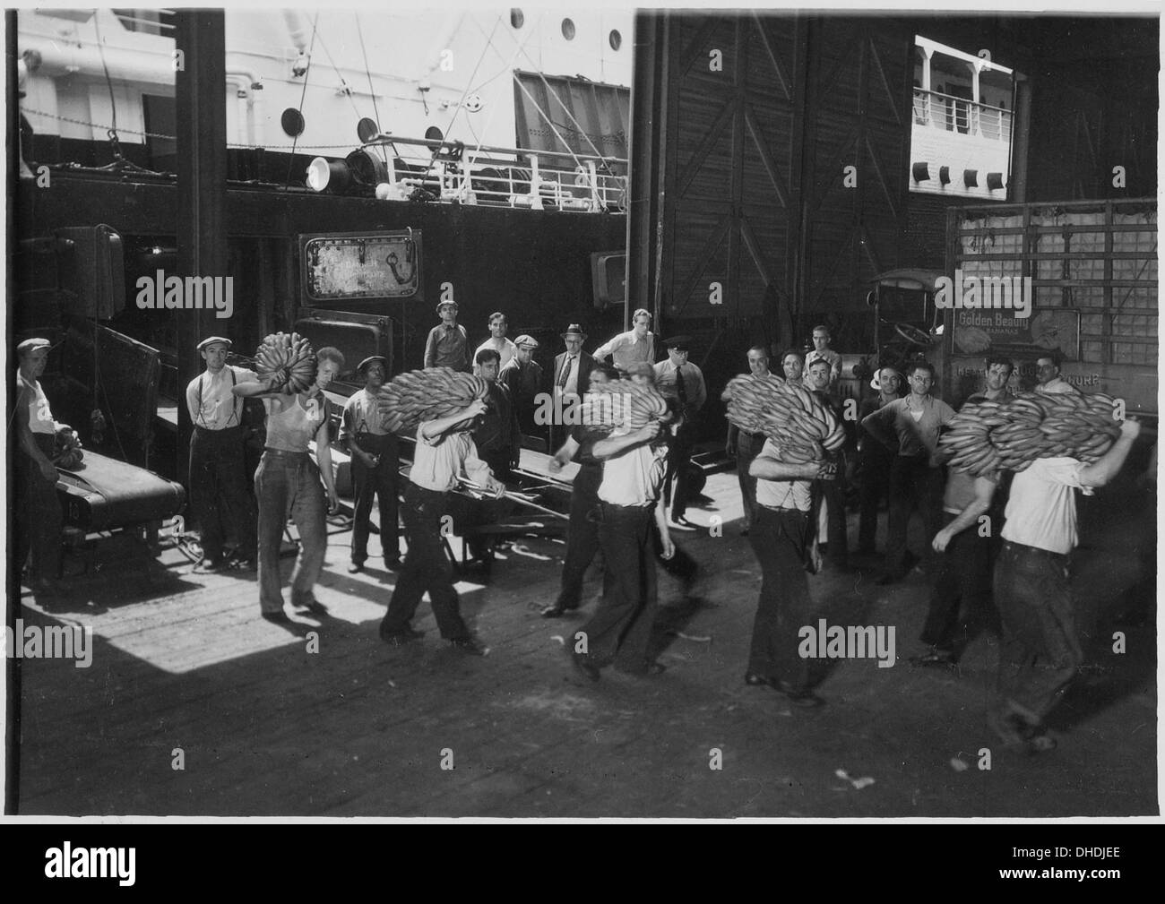 Longshoremen in New York are shown transferring bananas from cargo ...