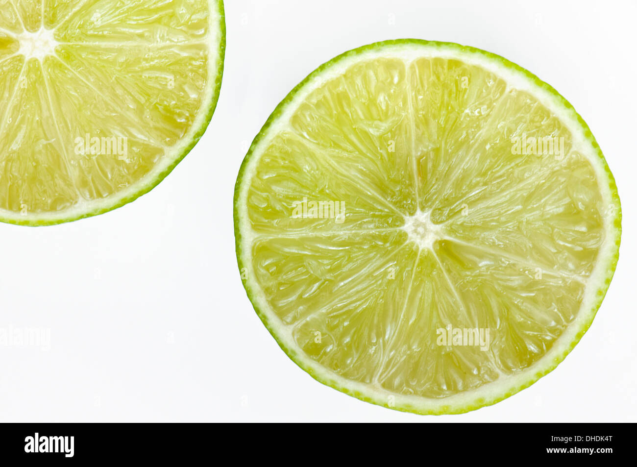 Halved lime segments on white background Stock Photo - Alamy