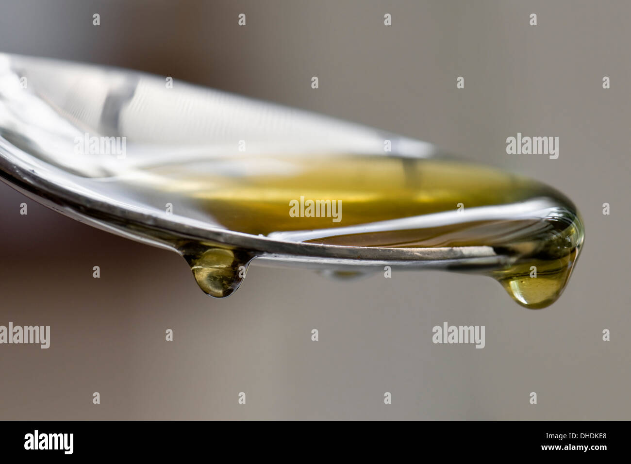 Runny honey dripping off spoon Stock Photo - Alamy